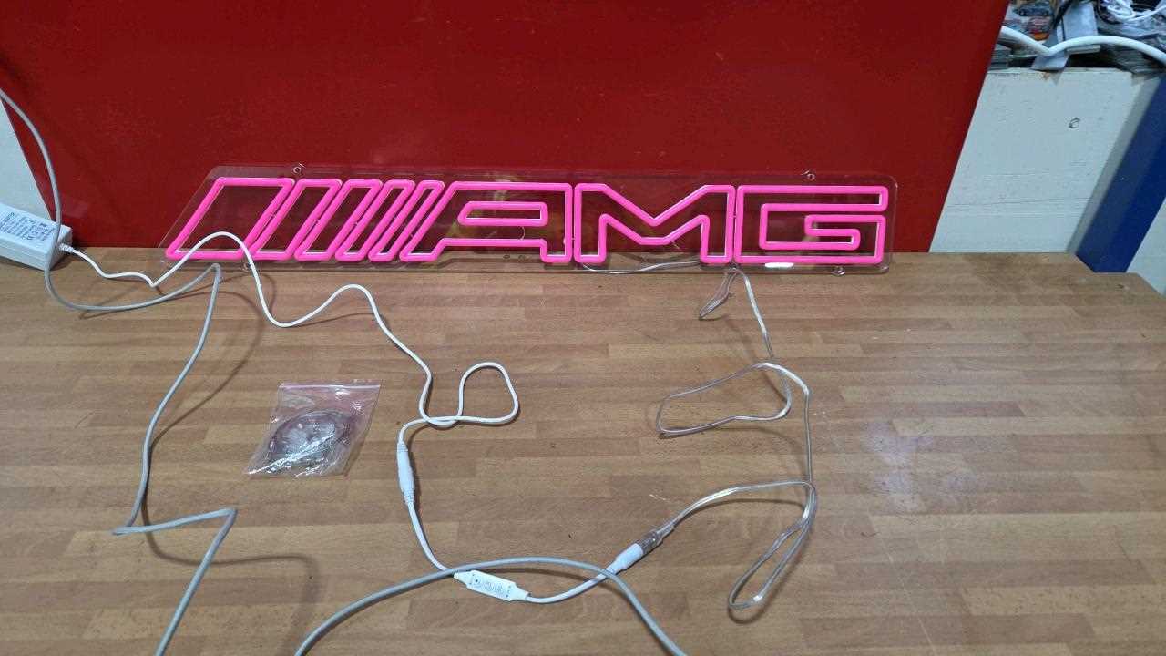 Lot 805 - PINK AMG NEON LIGHT UP SIGN 33" X 4.5"